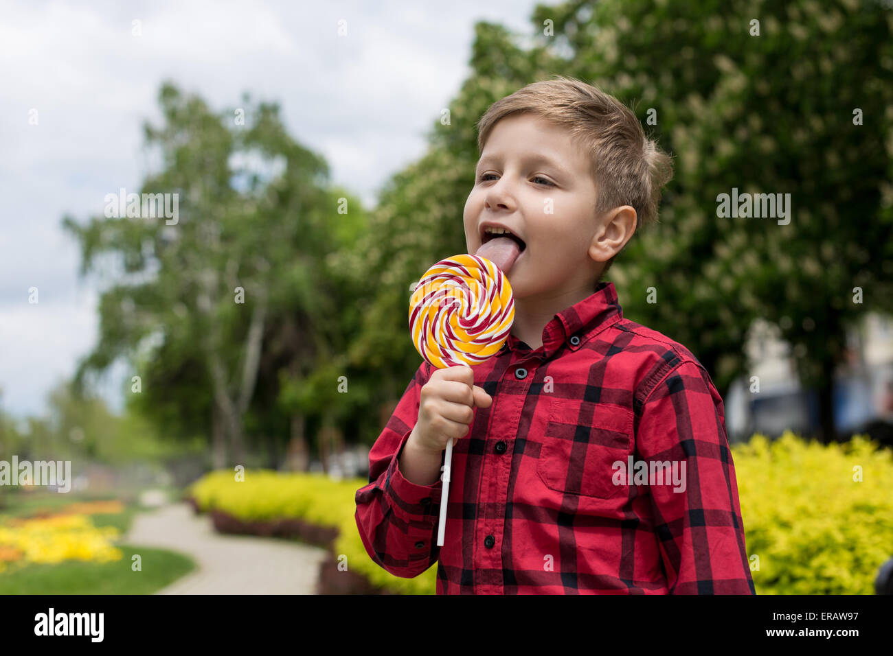happy little boy with big candy outdoor Stock Photo - Alamy