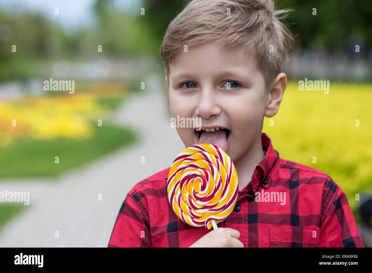 happy little boy with big candy outdoor Stock Photo - Alamy