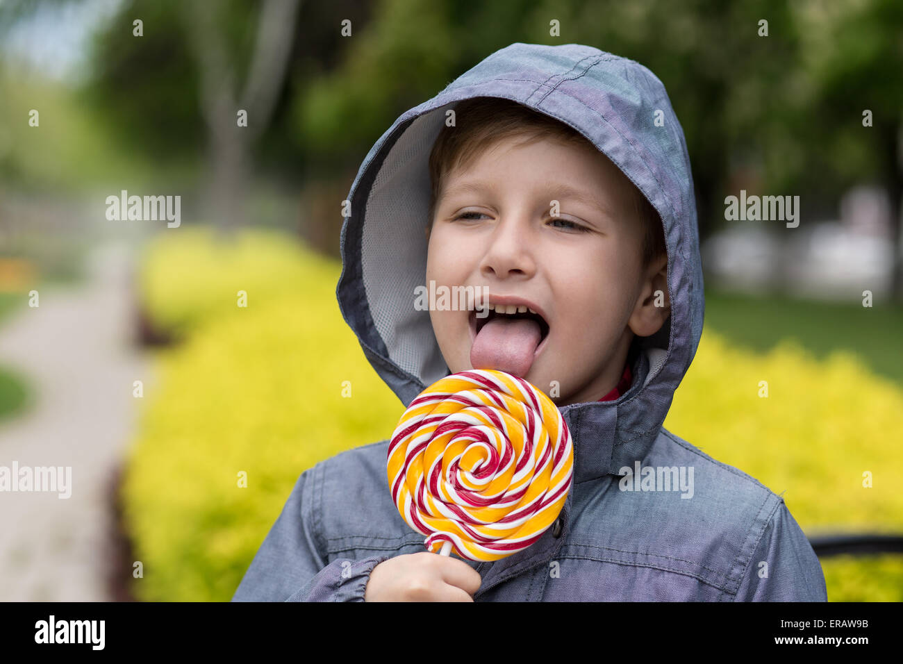 happy little boy with big candy outdoor Stock Photo - Alamy