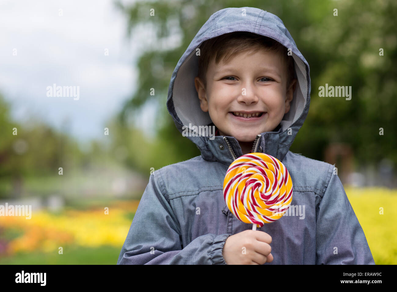 happy little boy with big candy outdoor Stock Photo - Alamy