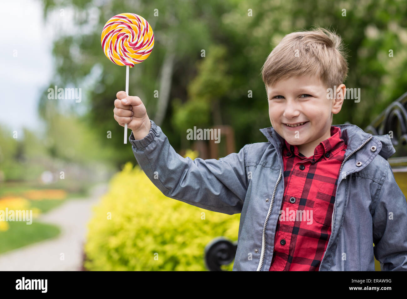 happy little boy with big candy outdoor Stock Photo - Alamy