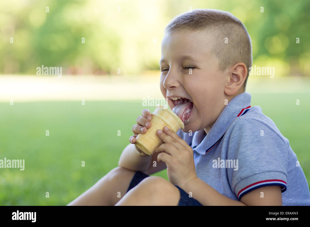 Little kid eating ice cream Stock Photo - Alamy