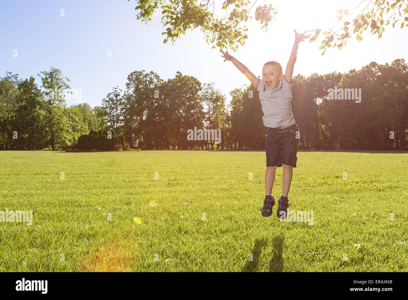 happy little boy laying on the grass Stock Photo - Alamy