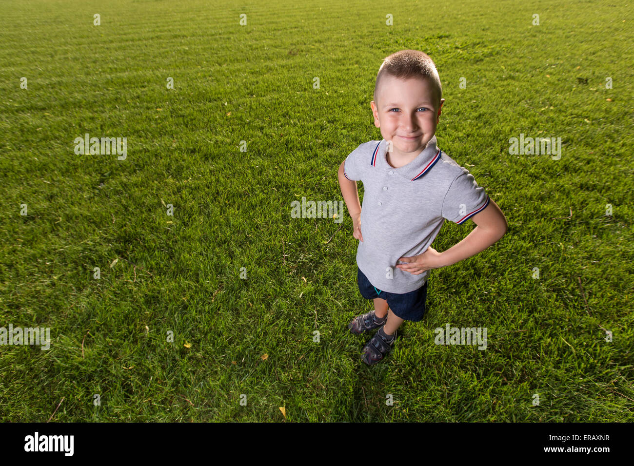 happy little boy laying on the grass Stock Photo - Alamy