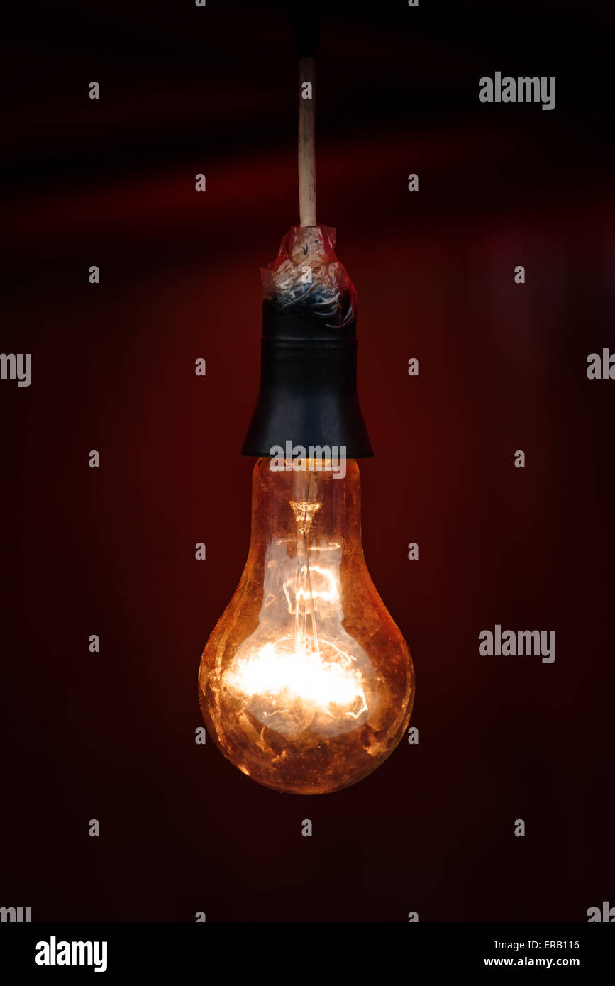 Vintage Light Bulb Shining on Red Background Stock Photo - Alamy
