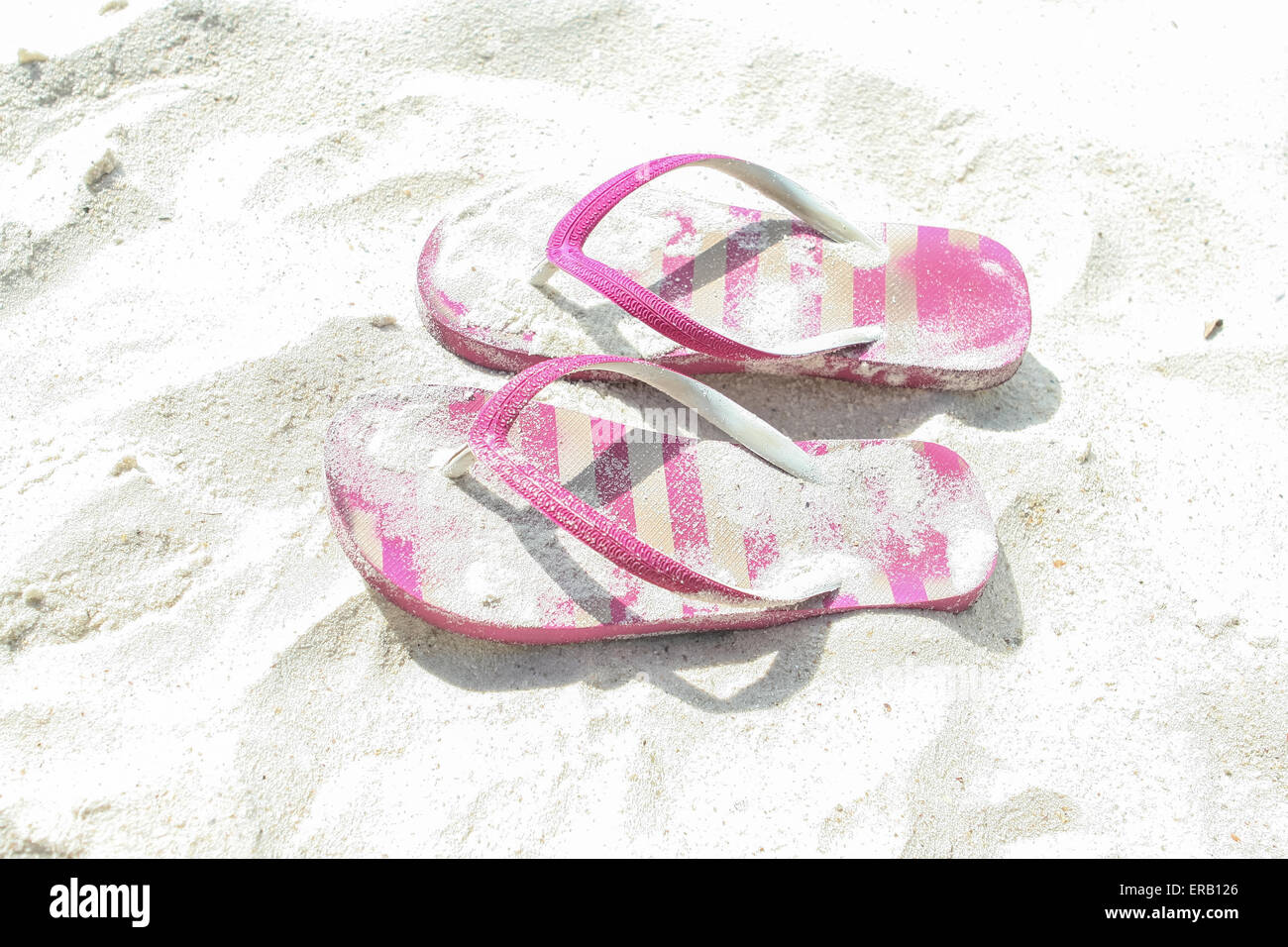 Pair of pink striped old sandal on white background Stock Photo - Alamy