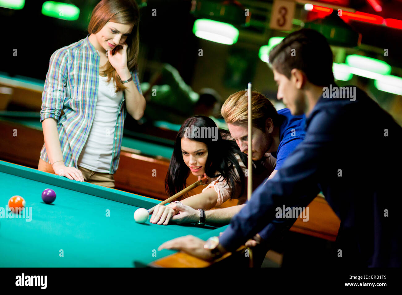 Young people playing pool Stock Photo - Alamy