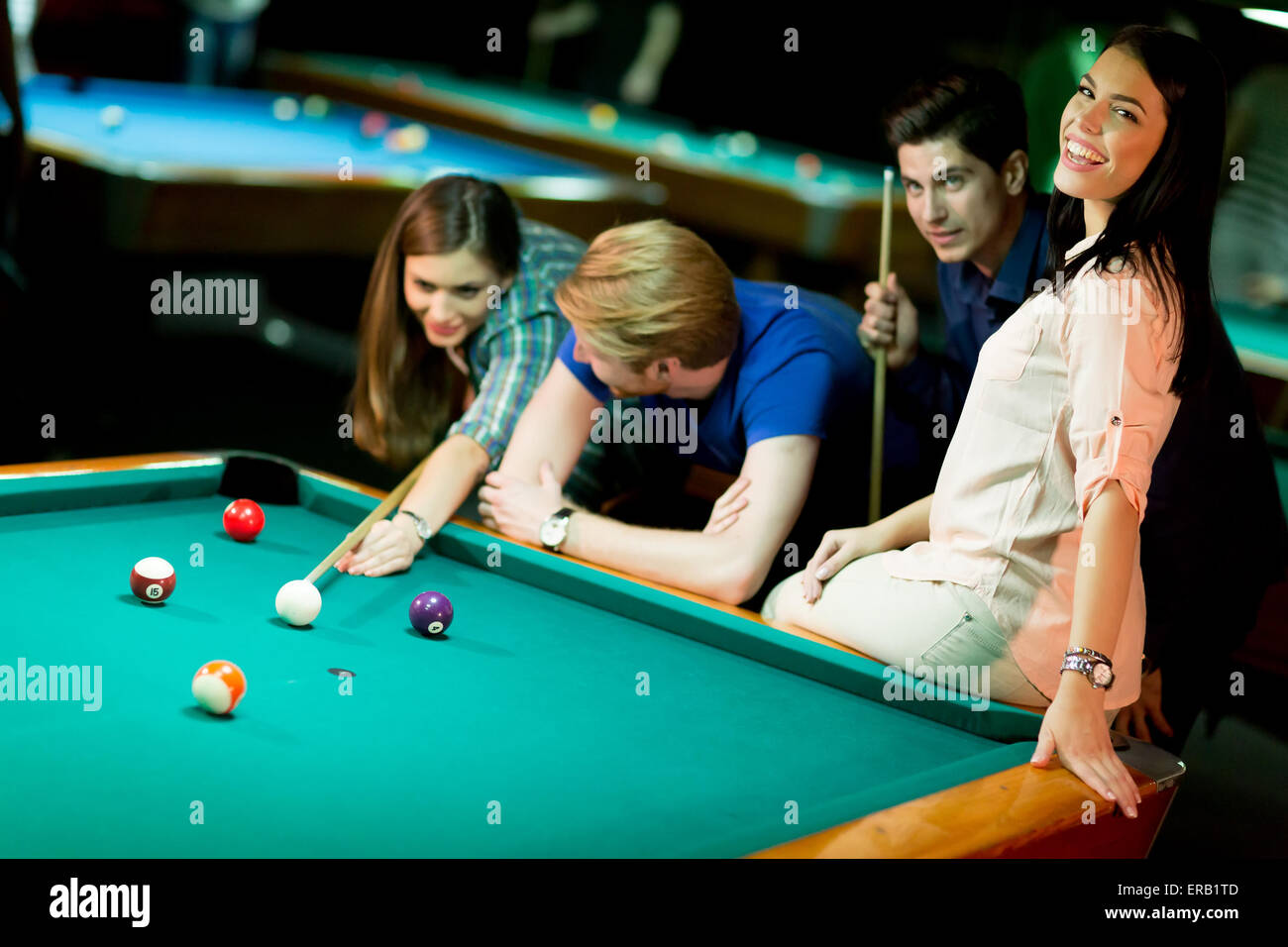 Young people playing pool Stock Photo - Alamy