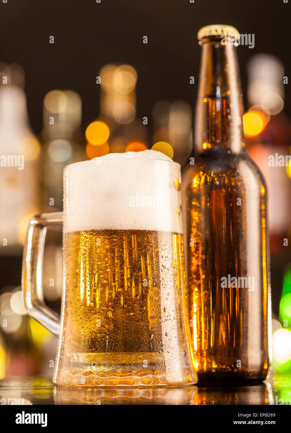 Jug of beer with bottle, placed on bar counter Stock Photo - Alamy