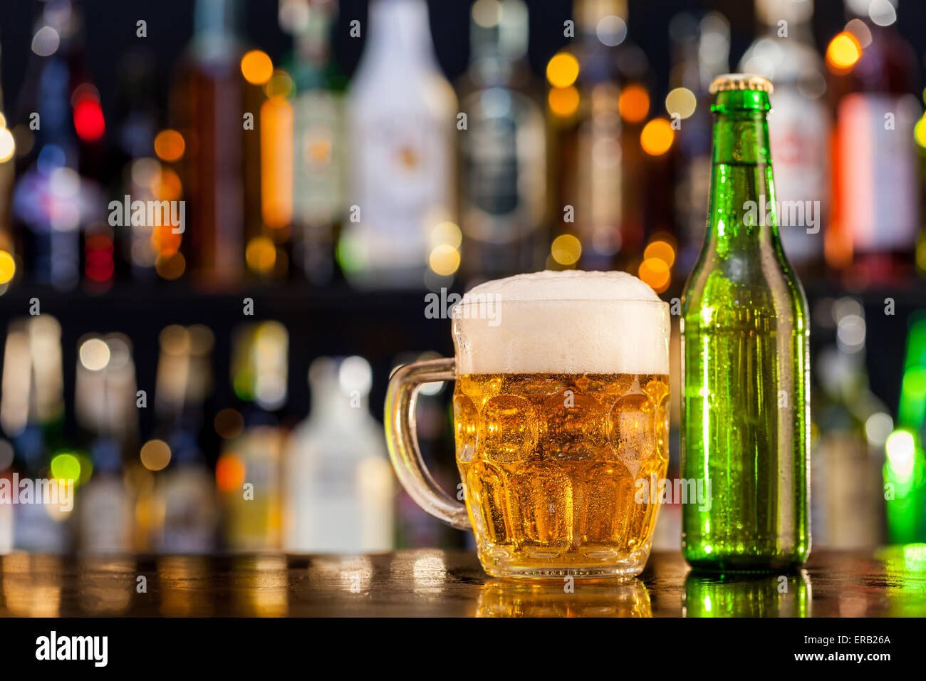 Jug of beer with bottle, placed on bar counter with copyspace Stock ...