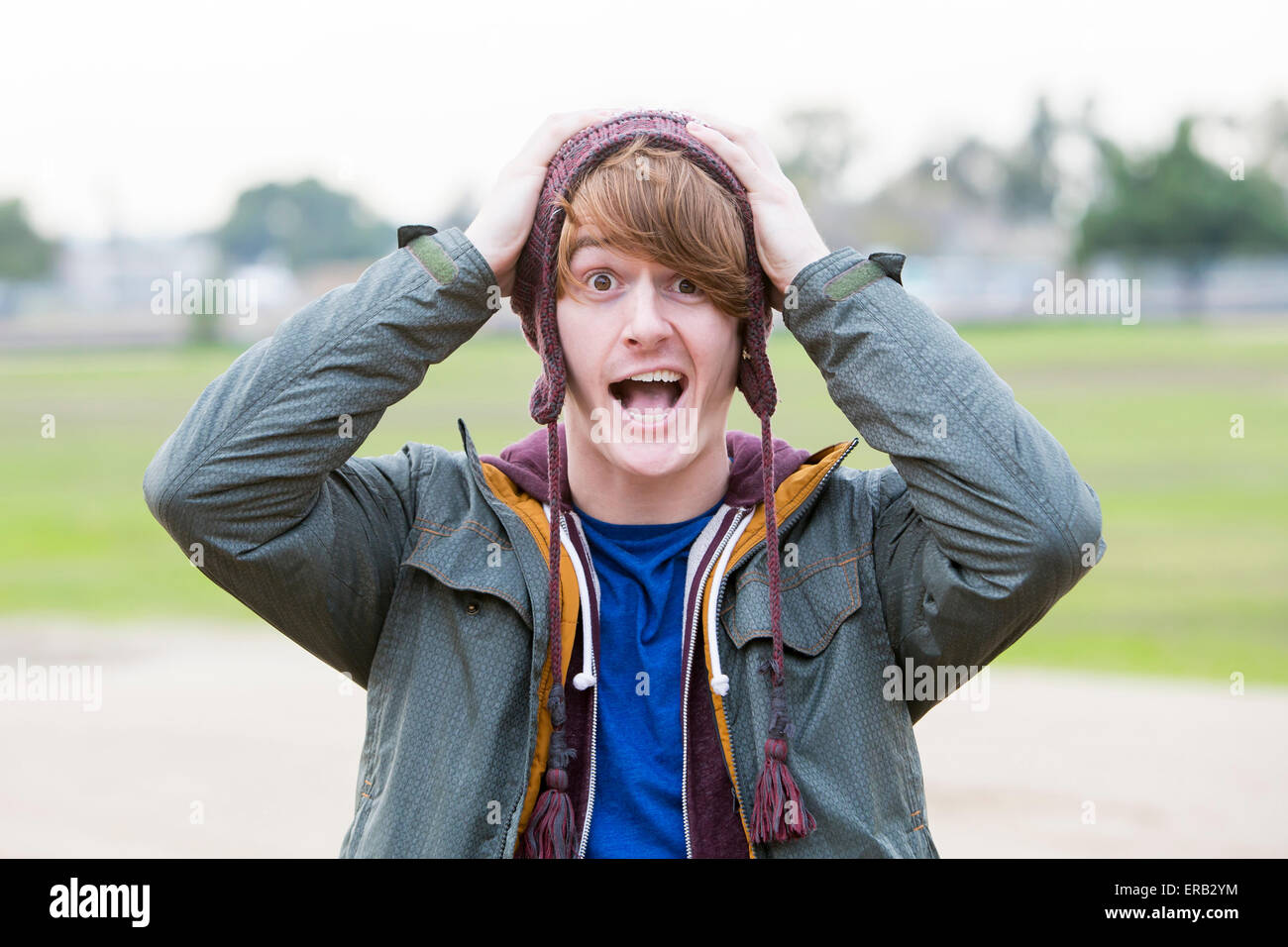 portrait of a smiling handsome young man in a hat Stock Photo - Alamy