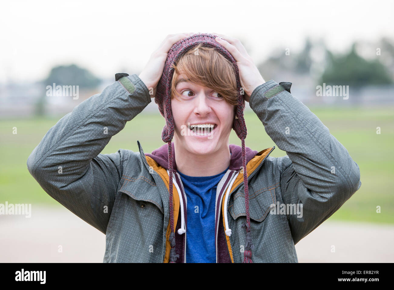 portrait of a smiling handsome young man in a hat Stock Photo - Alamy