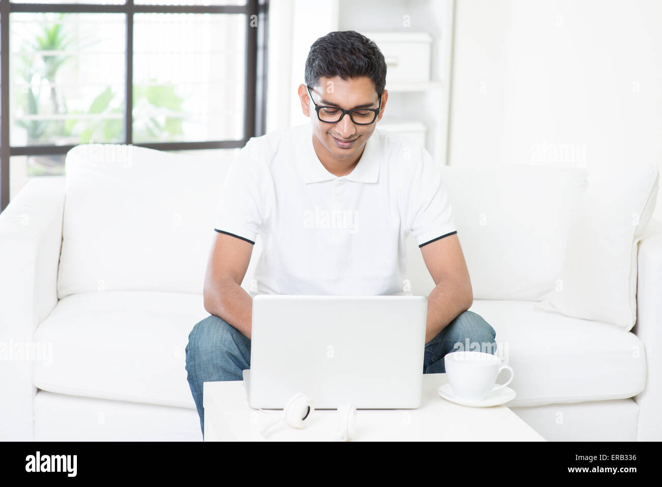 Young Indian guy start his new business with laptop computer from home ...