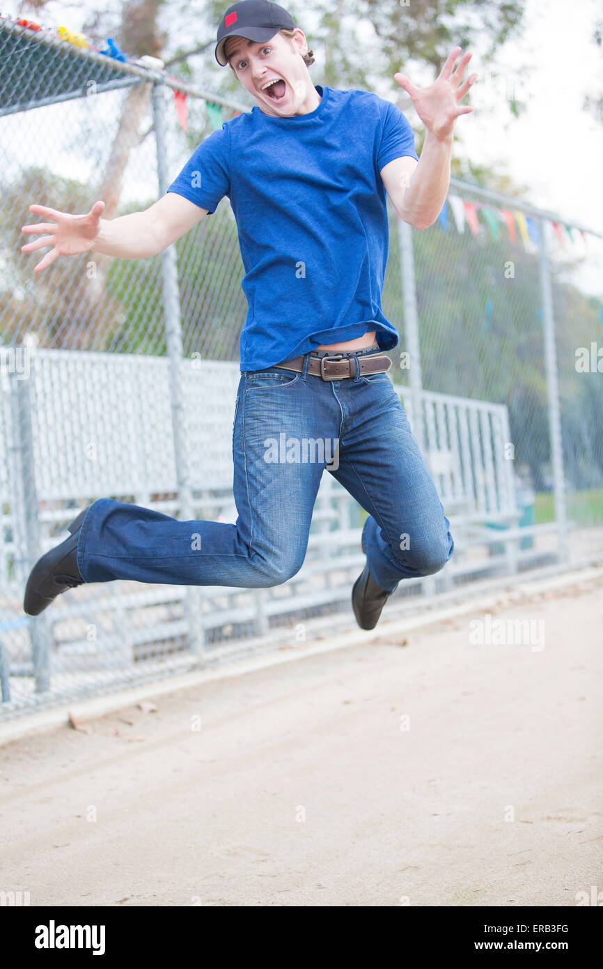 young man jumping on a sports field Stock Photo - Alamy
