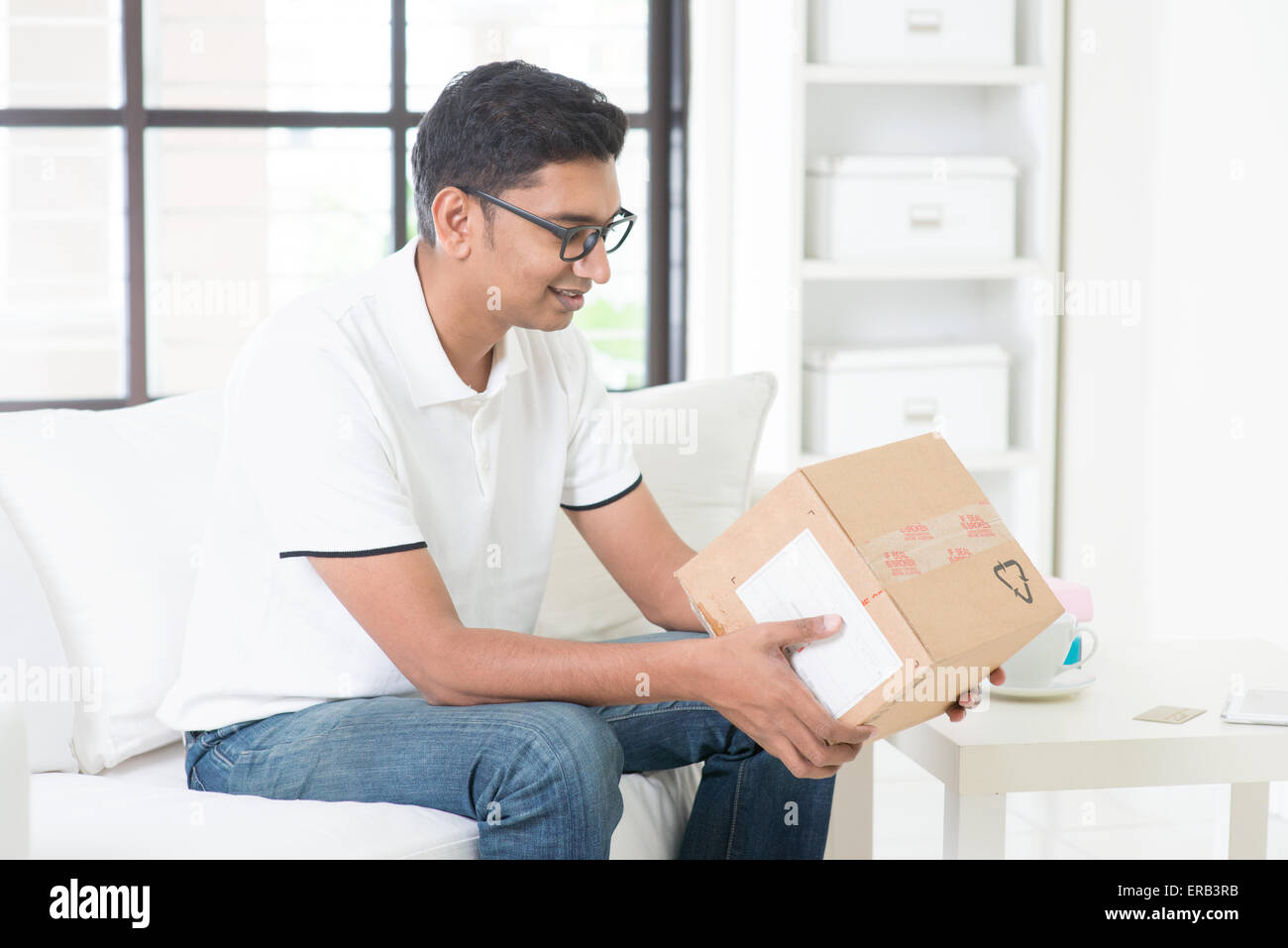 Courier delivery concept. Indian guy received an express parcel and ...