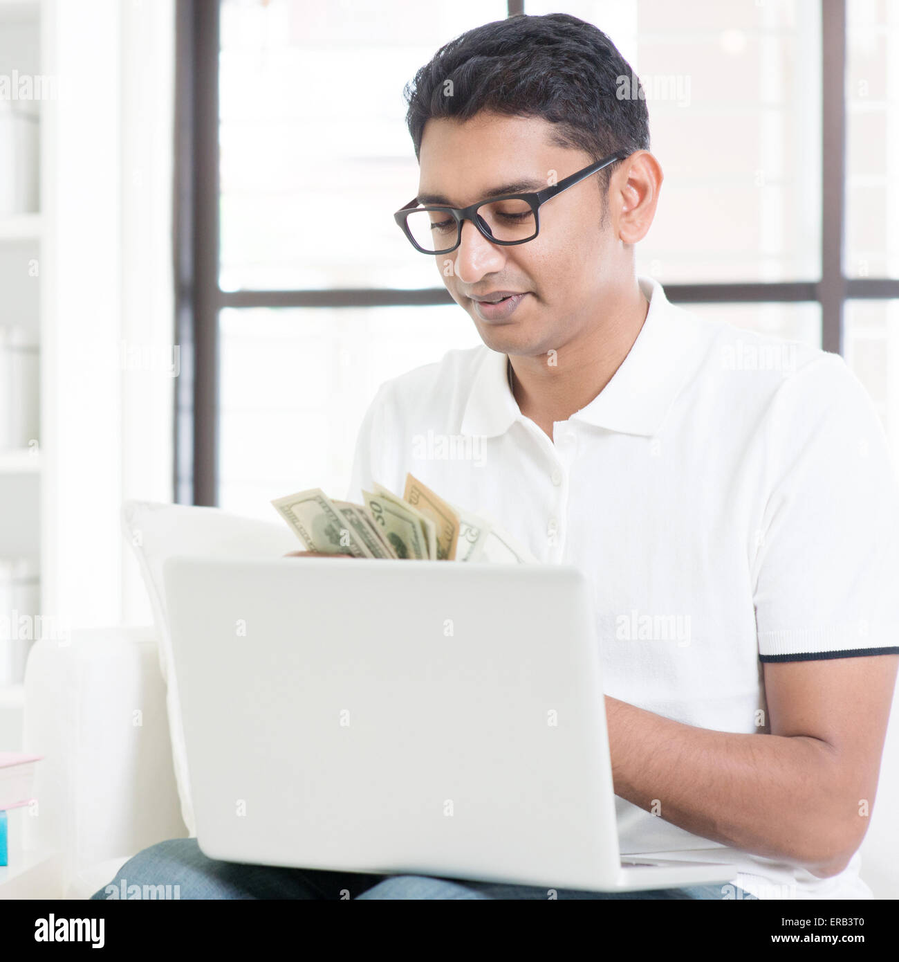 Indian guy counting cash, earning money from his successful internet ...