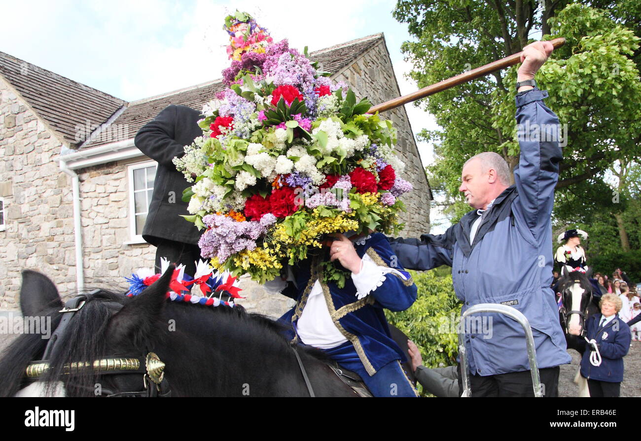 Wearing a floral headdress, the Garland King processes through ...