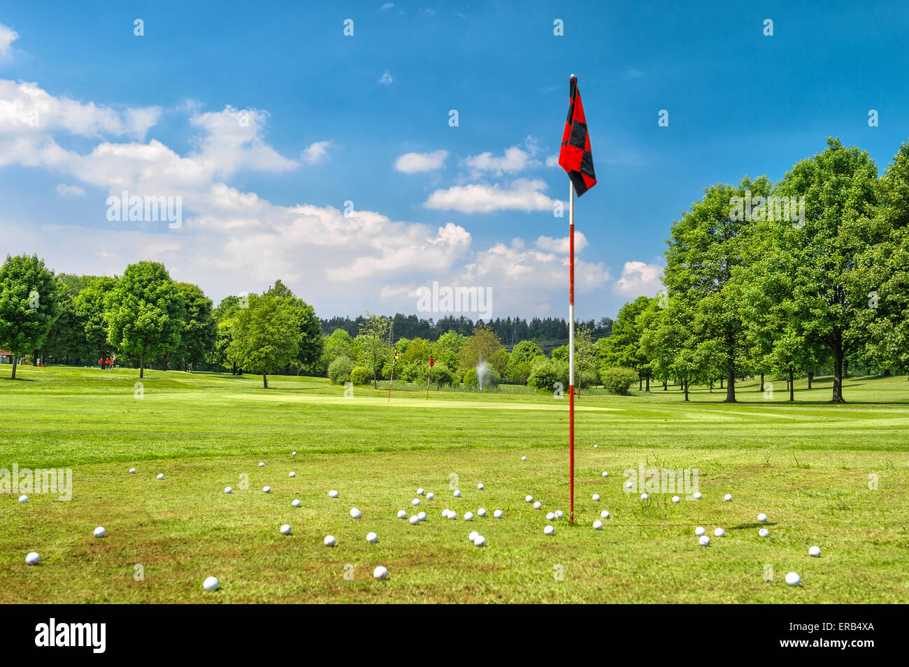 Golf field and cloudy blue sky. European spring landscape with green ...