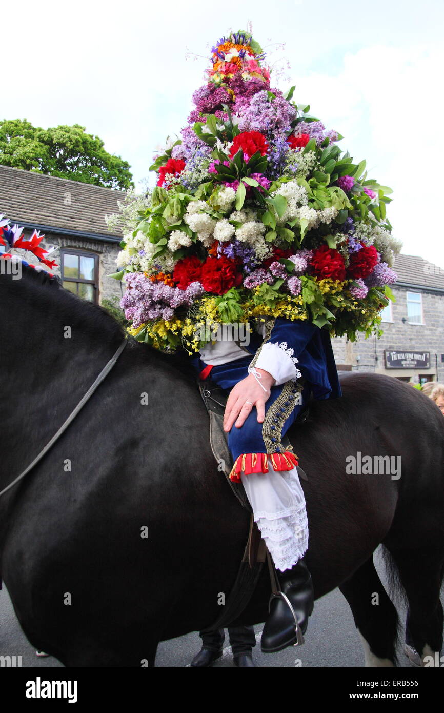 Wearing a floral headdress, the Garland King processes through ...