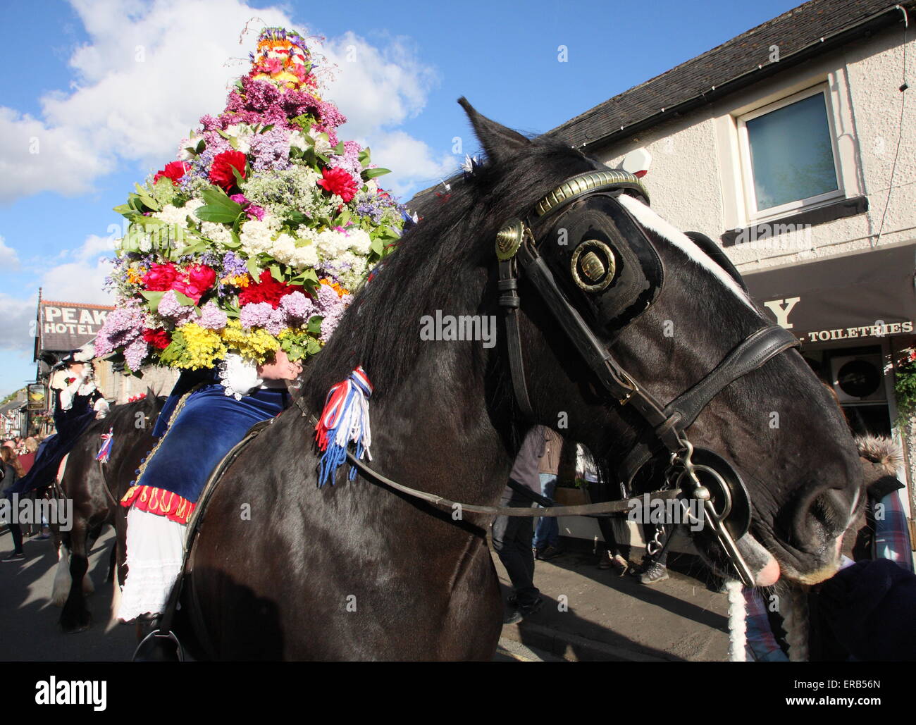 Wearing a floral headdress, the Garland King processes through ...