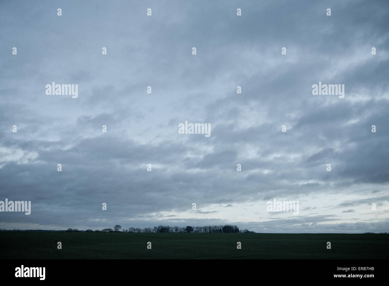 Clouds over a green landscape Stock Photo - Alamy