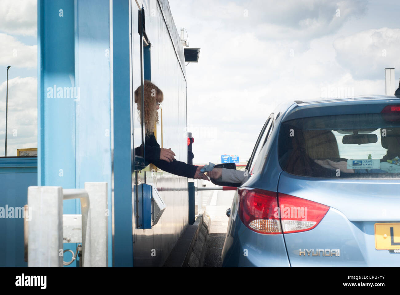 English car paying cash at a french toll booth on the autoroute ...