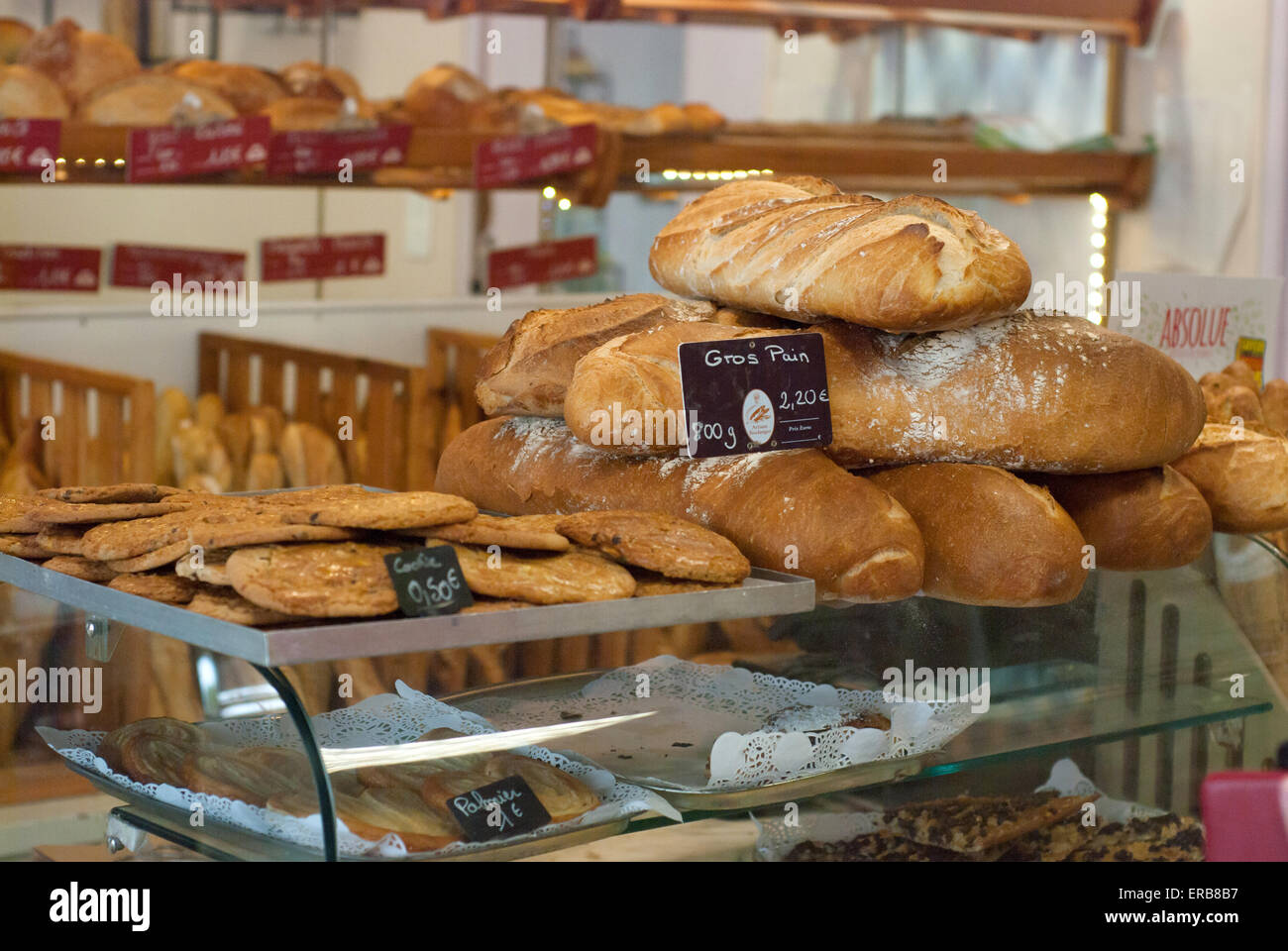 Inside a typical french boulangerie with various types of fresh loaves ...