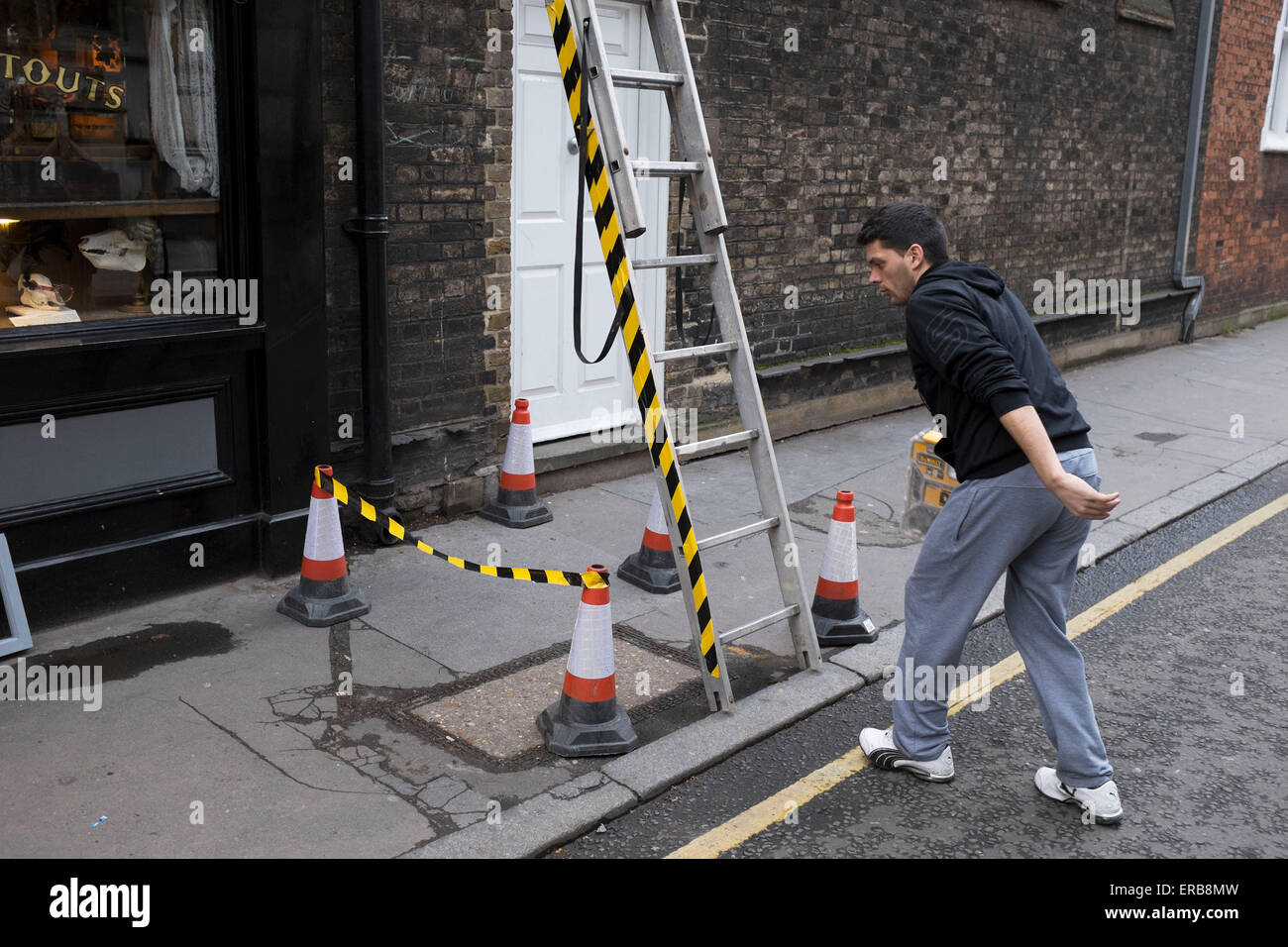 Health and safety in use around a ladder where workmen are climbing up ...