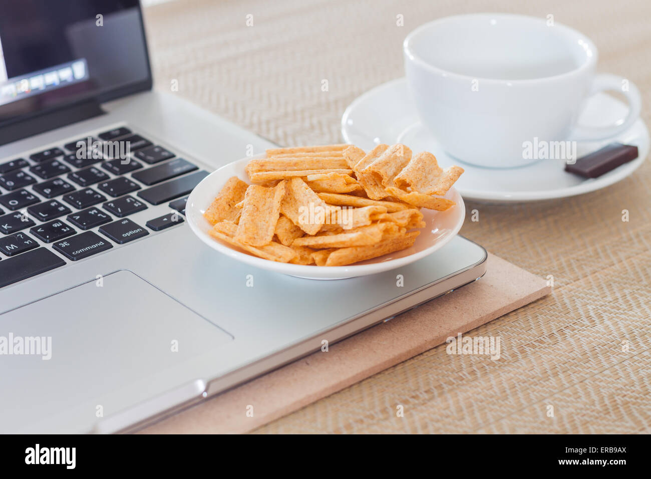 Laptop with coffee cup and snack, stock photo Stock Photo - Alamy