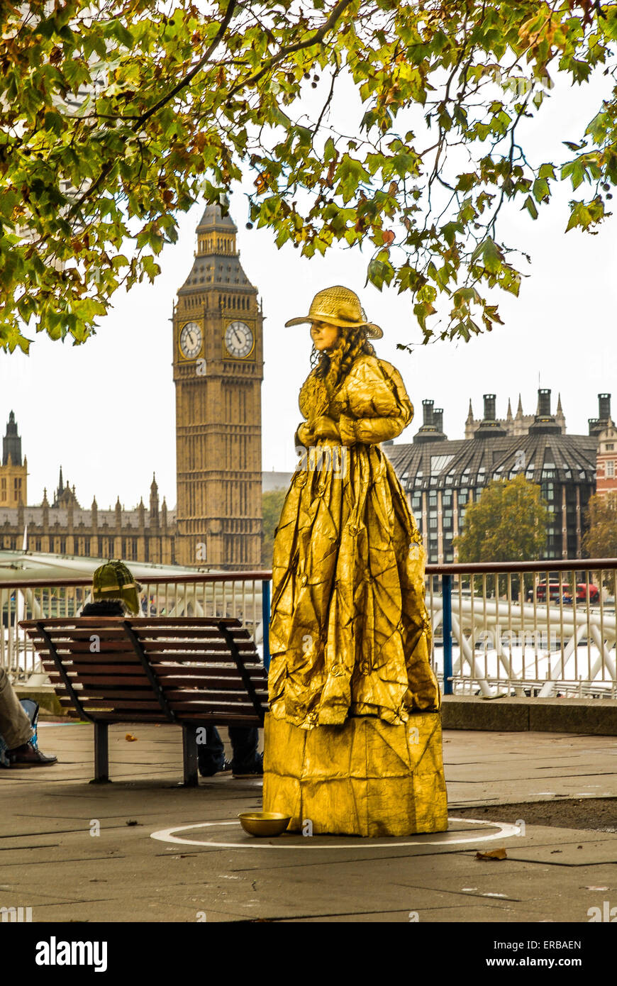 Golden living statue on river bank of Thames with Big Ben on background, London Stock Photo - Alamy