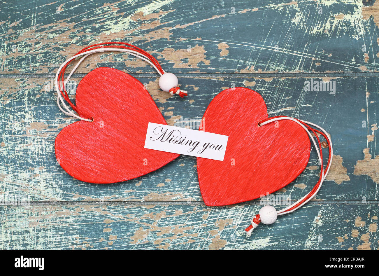 Missing you card with two red wooden hearts Stock Photo - Alamy