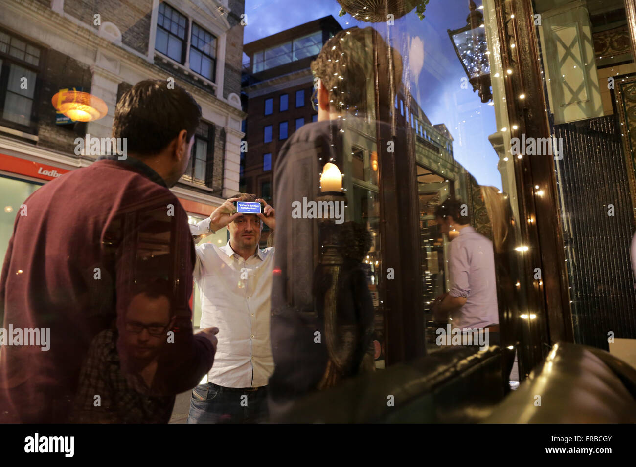 a group of drunk males outside a pub playing a game of 'who am I', a ...