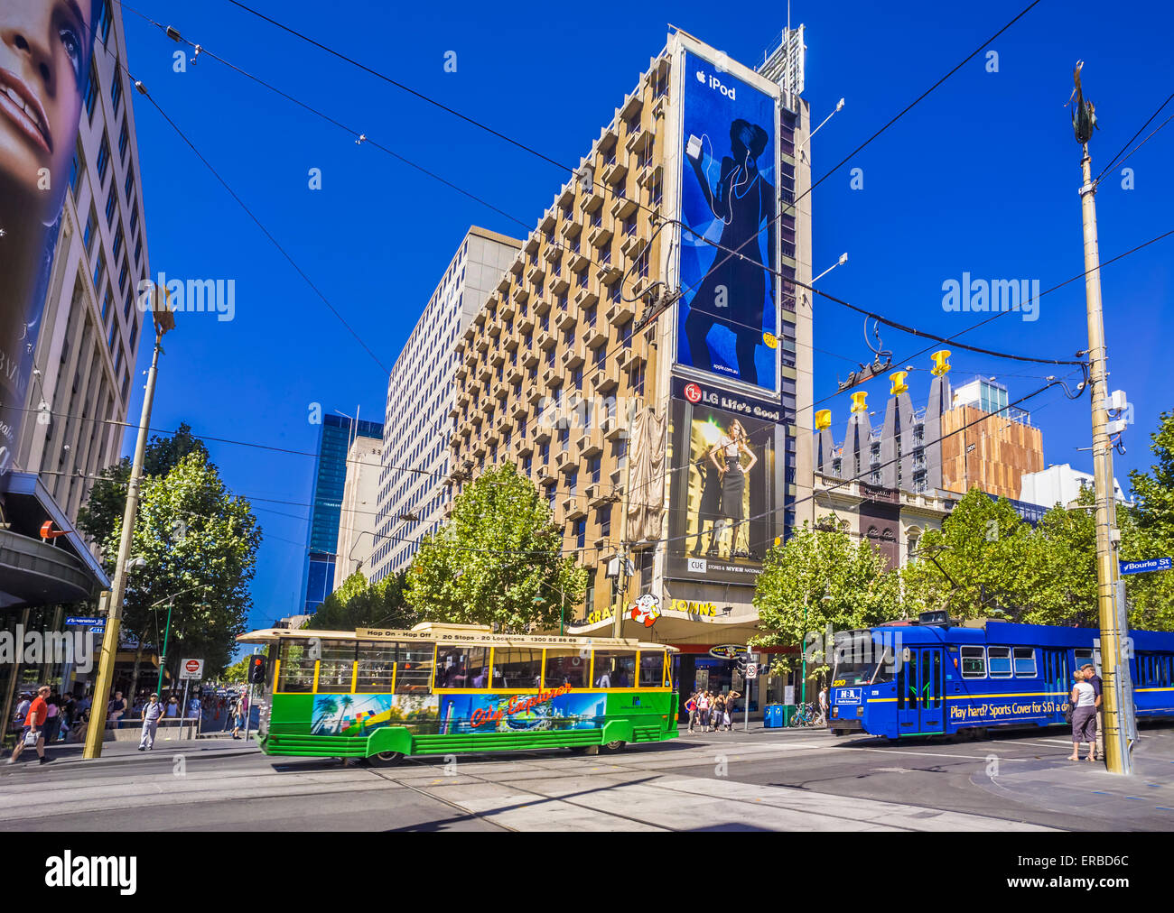 Iconic heritage green and yellow tram and bright blue modern tram in ...