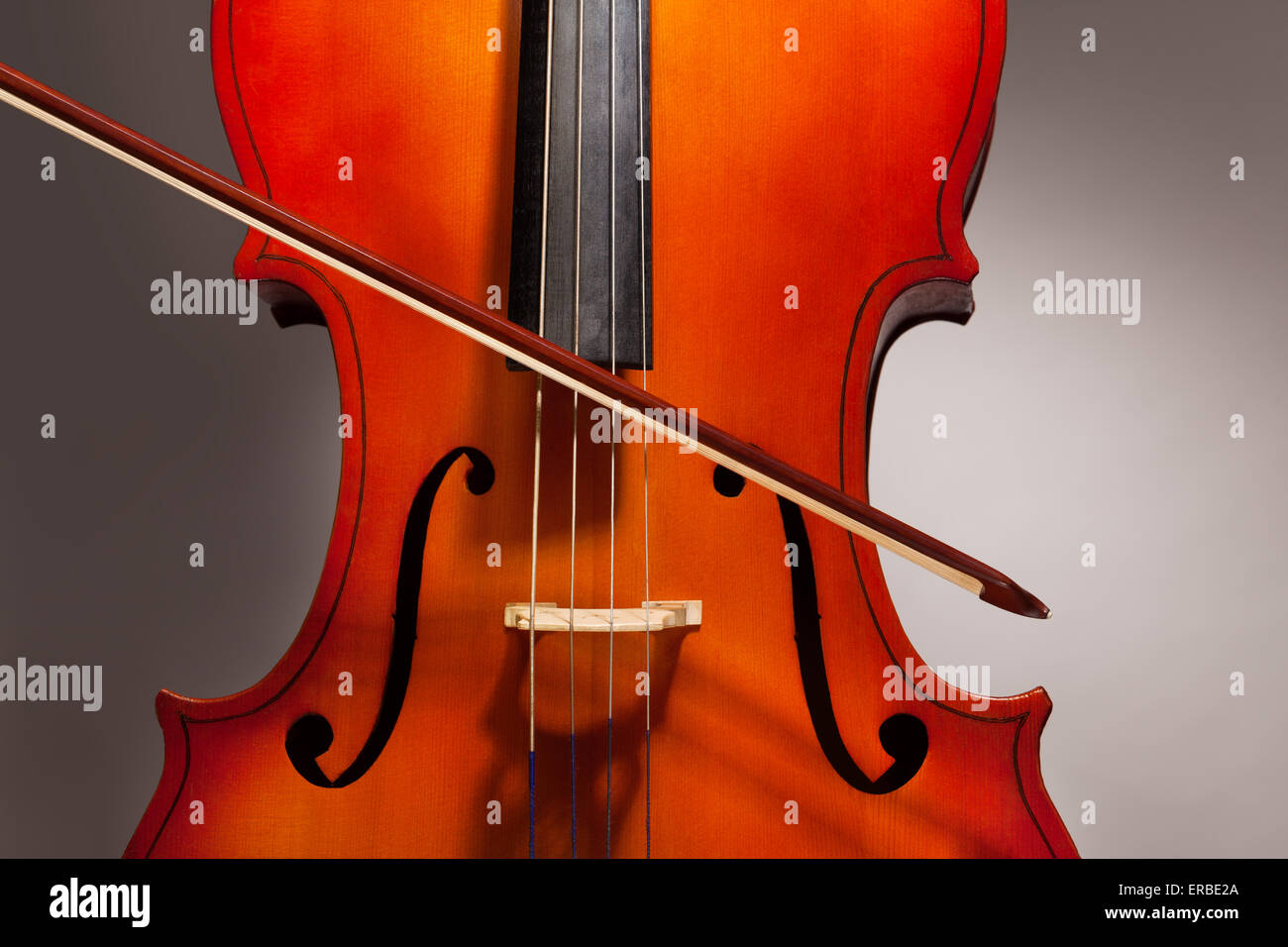 Violoncello with bow stick on the grey background Stock Photo - Alamy