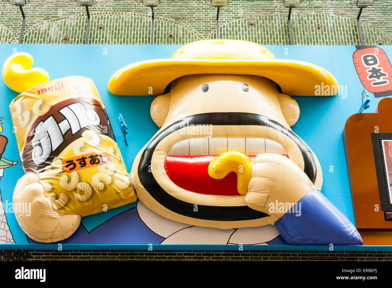 Japan, Osaka, Dotonbori. Large model sign on store facade of face of ...