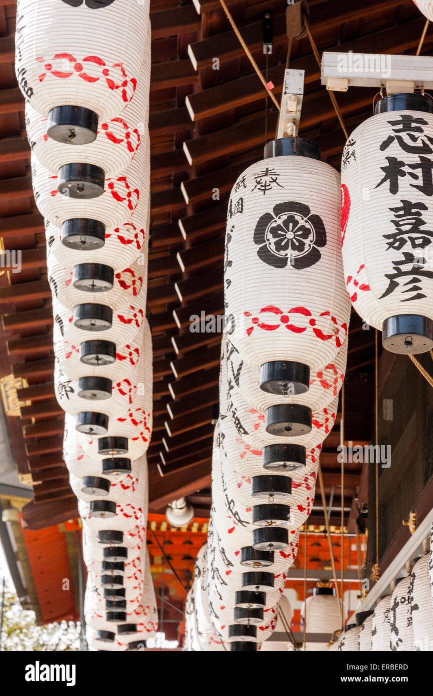 Rows of white chochin, paper lanterns, hanging from the roof of the ...