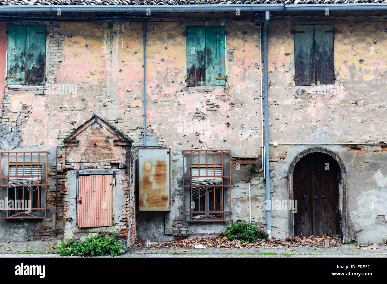 Rusty windows and doors in ruined wall of an old farmhouse in ...