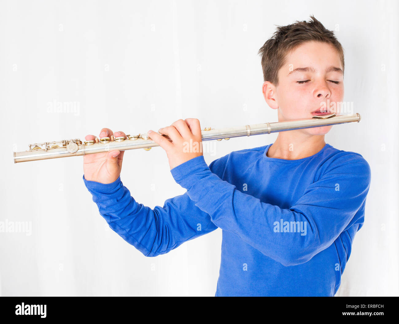 portrait of a boy playing the flute with his eyes closed Stock Photo ...