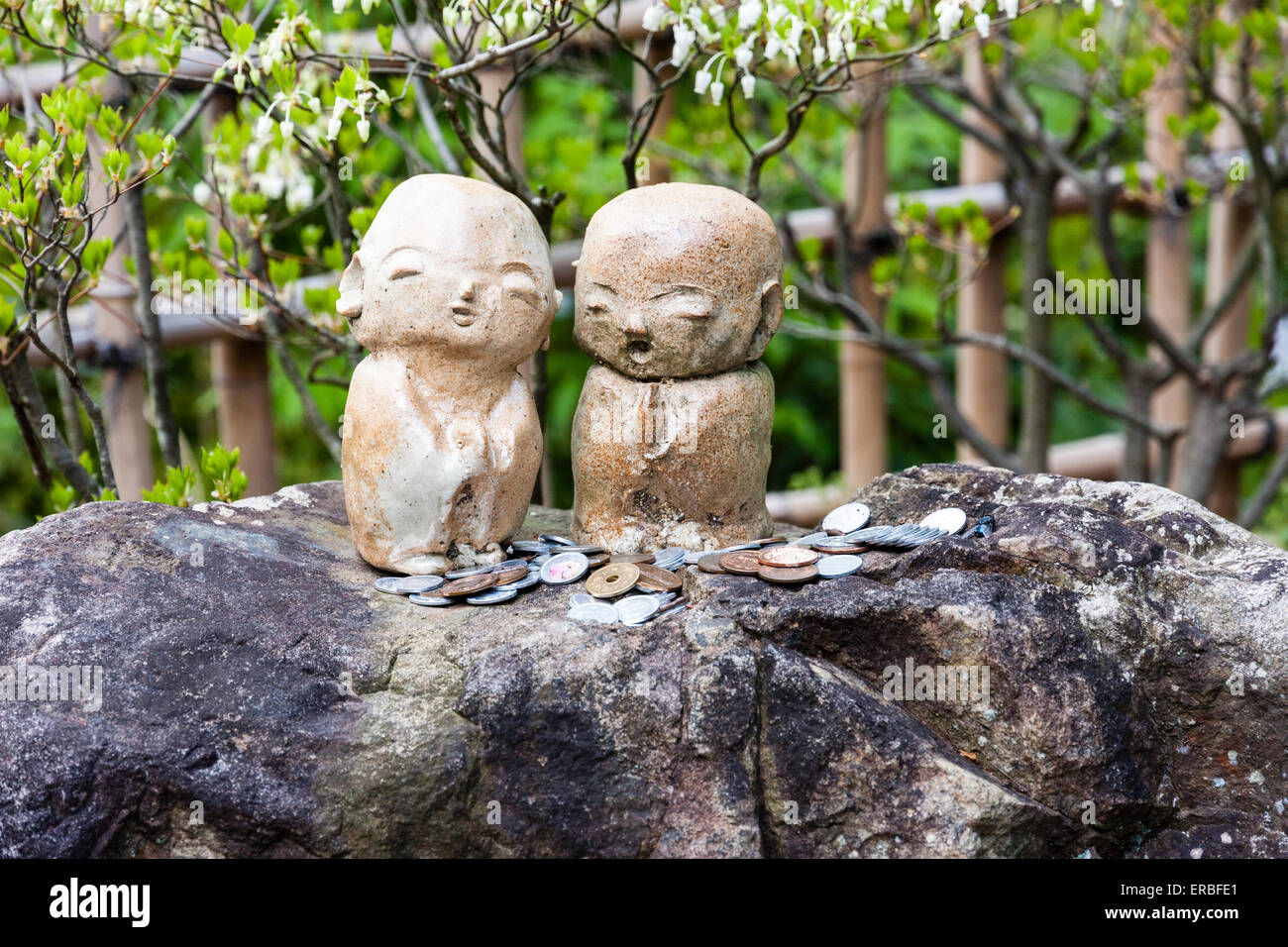 Two Japanese Jizo statues, set together as couple, standing on a large ...
