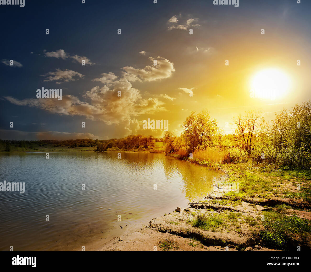Sake shore covered with green grass at sunset Stock Photo - Alamy