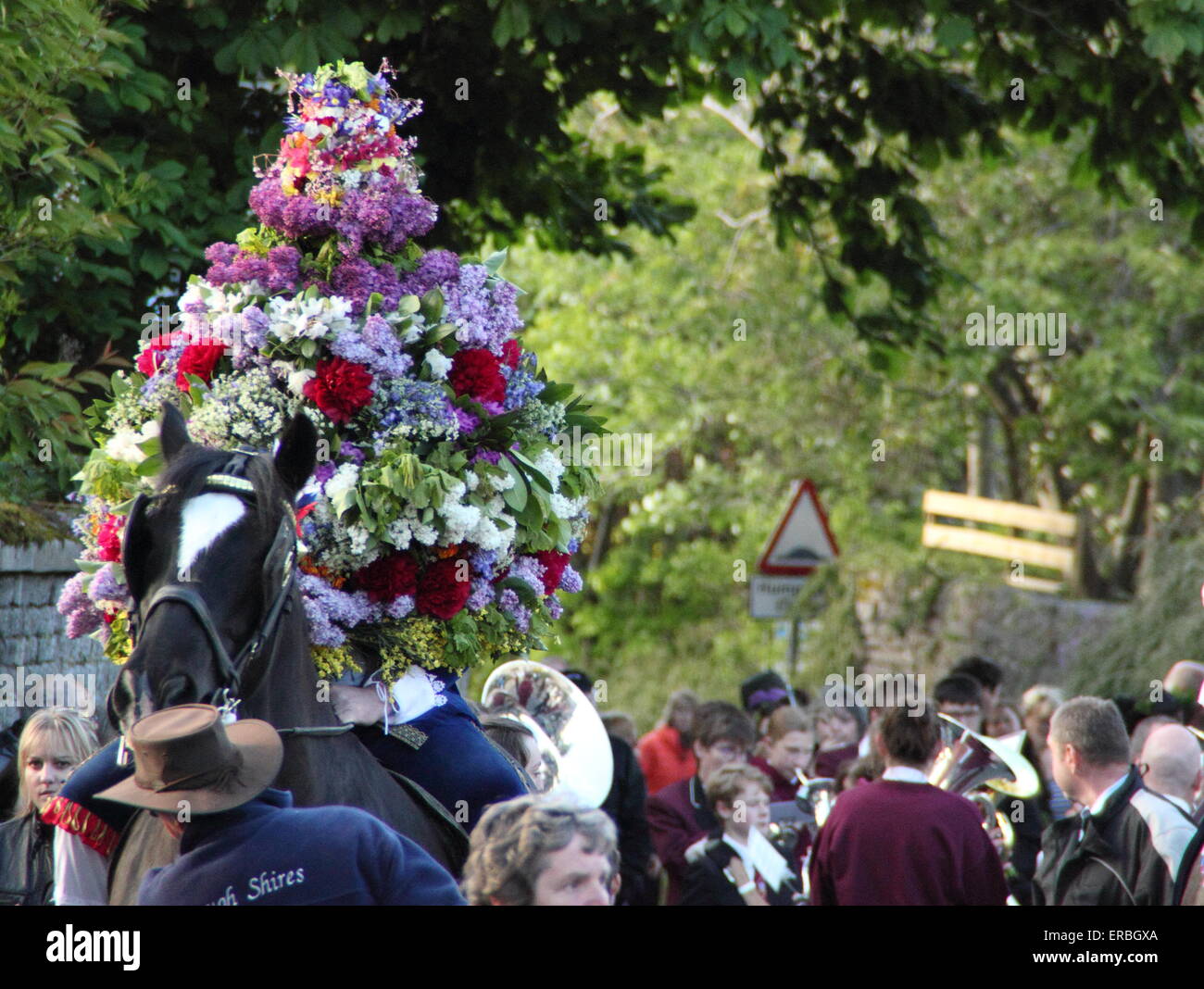 Wearing a floral headdress, the Garland King processes through ...