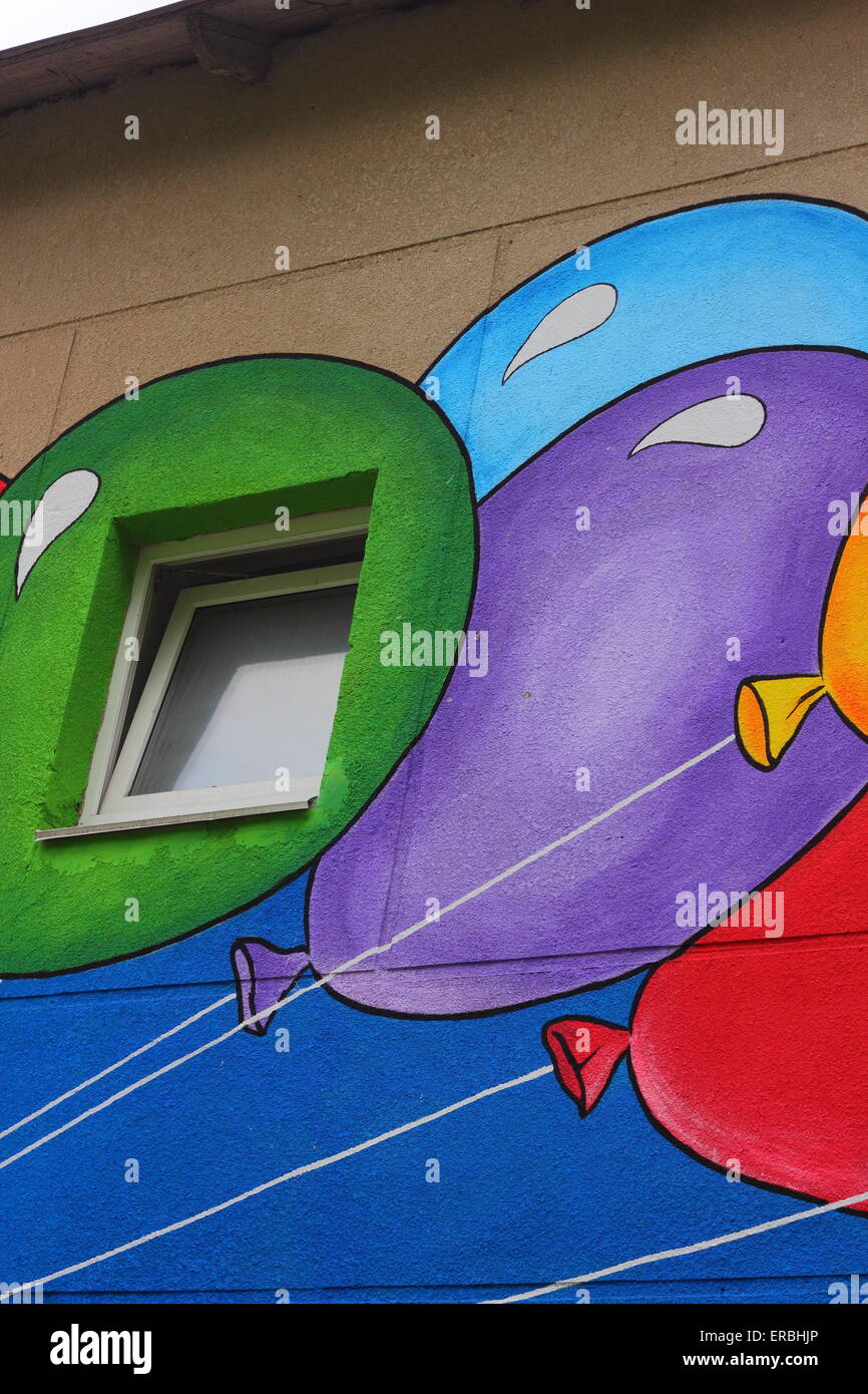 on the wall of a building painted colored balls Stock Photo - Alamy