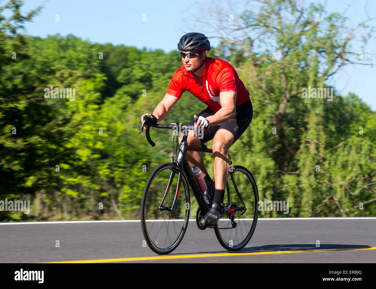 Man riding a road bike on a paved roadway Stock Photo - Alamy
