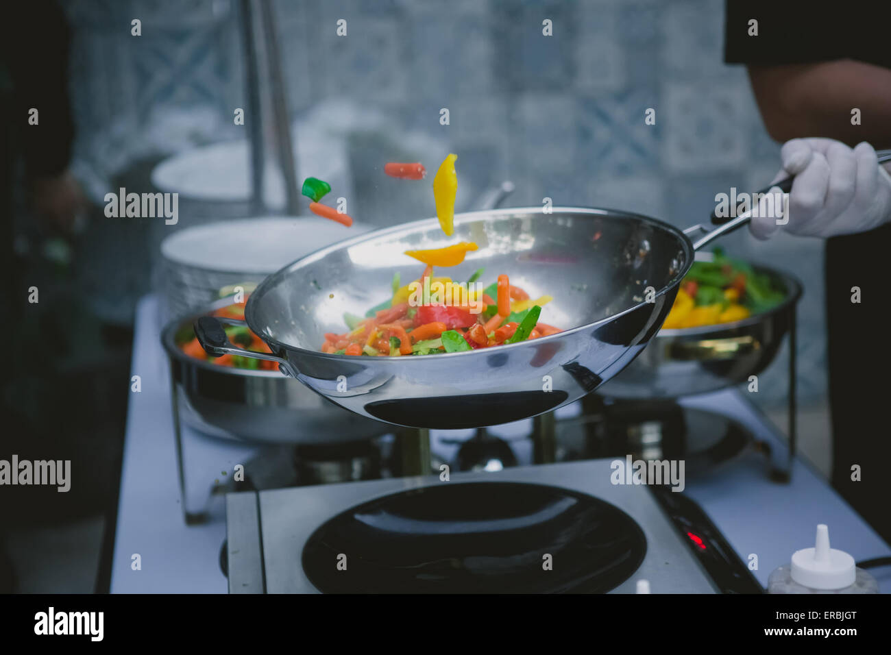 Chef cooking vegetables in wok pan. Shallow dof Stock Photo - Alamy