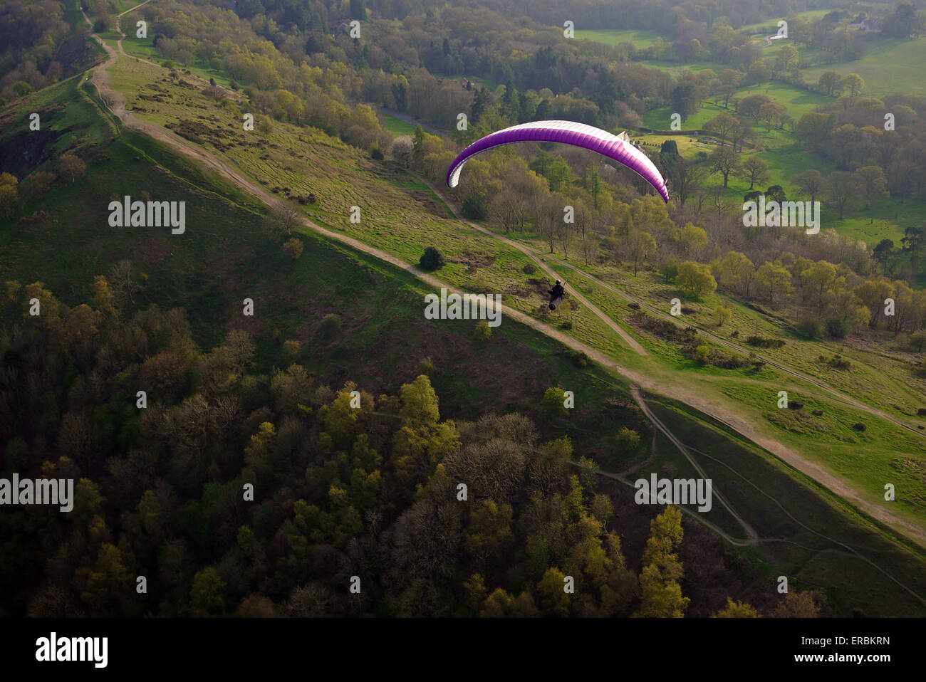 Single paraglider flying above the Malvern Hills on a spring evening ...