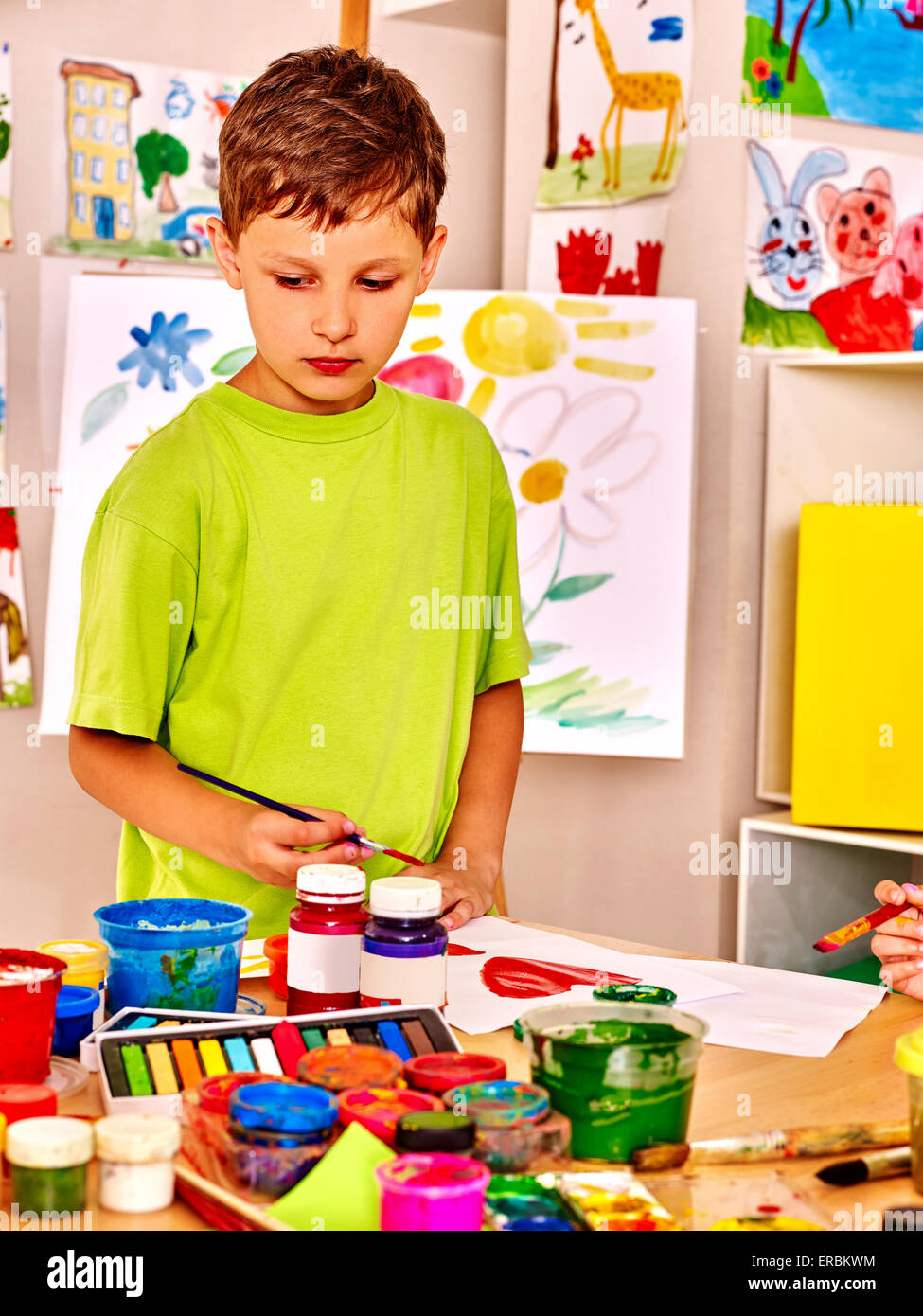 Child painting at easel Stock Photo - Alamy