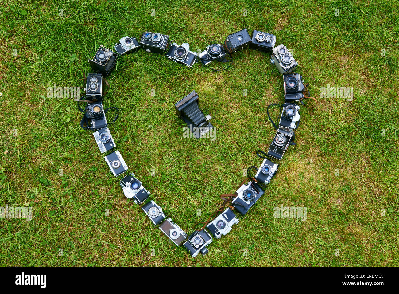 Heart shape made by collection of old vintage retro film cameras, lying ...