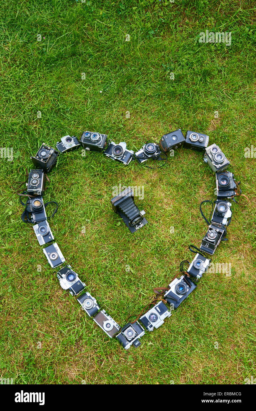Heart shape made by collection of old vintage retro film cameras, lying ...