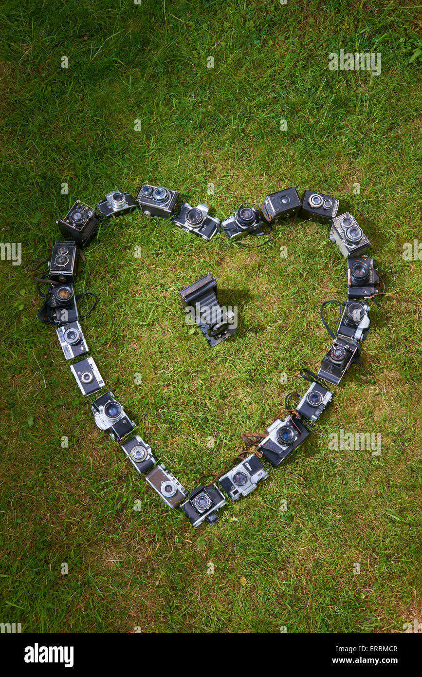 Heart shape made by collection of old vintage retro film cameras, lying ...