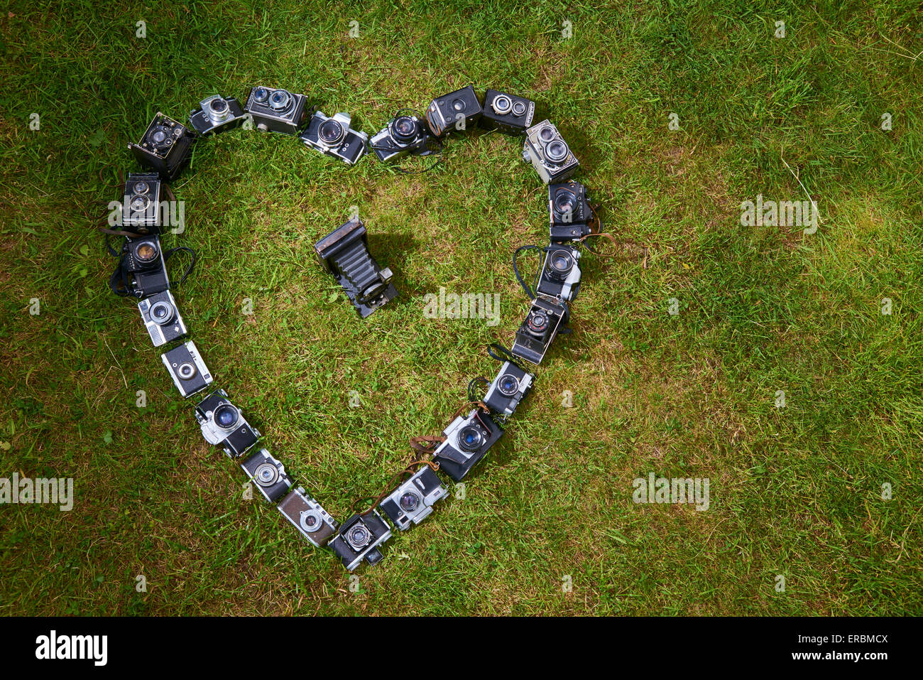 Heart shape made by collection of old vintage retro film cameras, lying ...
